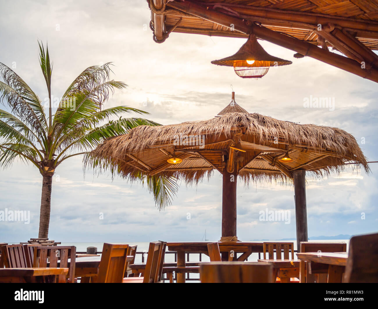 Bamboo hut pavilion with wooden chairs and table in restaurant on ...