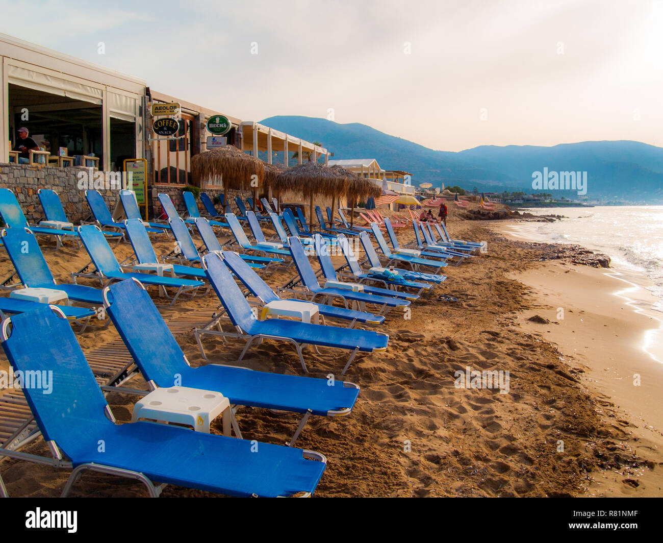 Blue beach chairs, mountains on the backgroundat a tropical resort at a ...