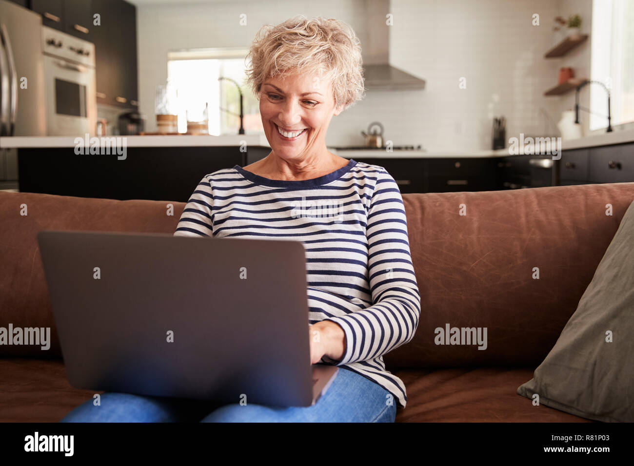 Woman and sitting on couch hi-res stock photography and images - Alamy