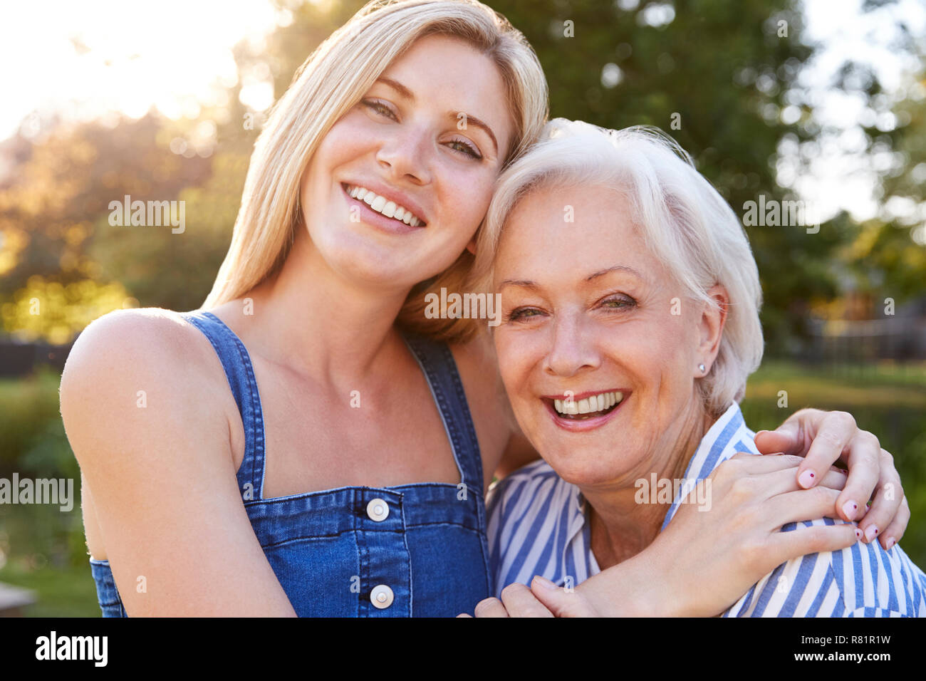 Portrait Of Smiling Mother Hugging Adult Daughter Outdoors In Summer Park Stock Photo - Alamy