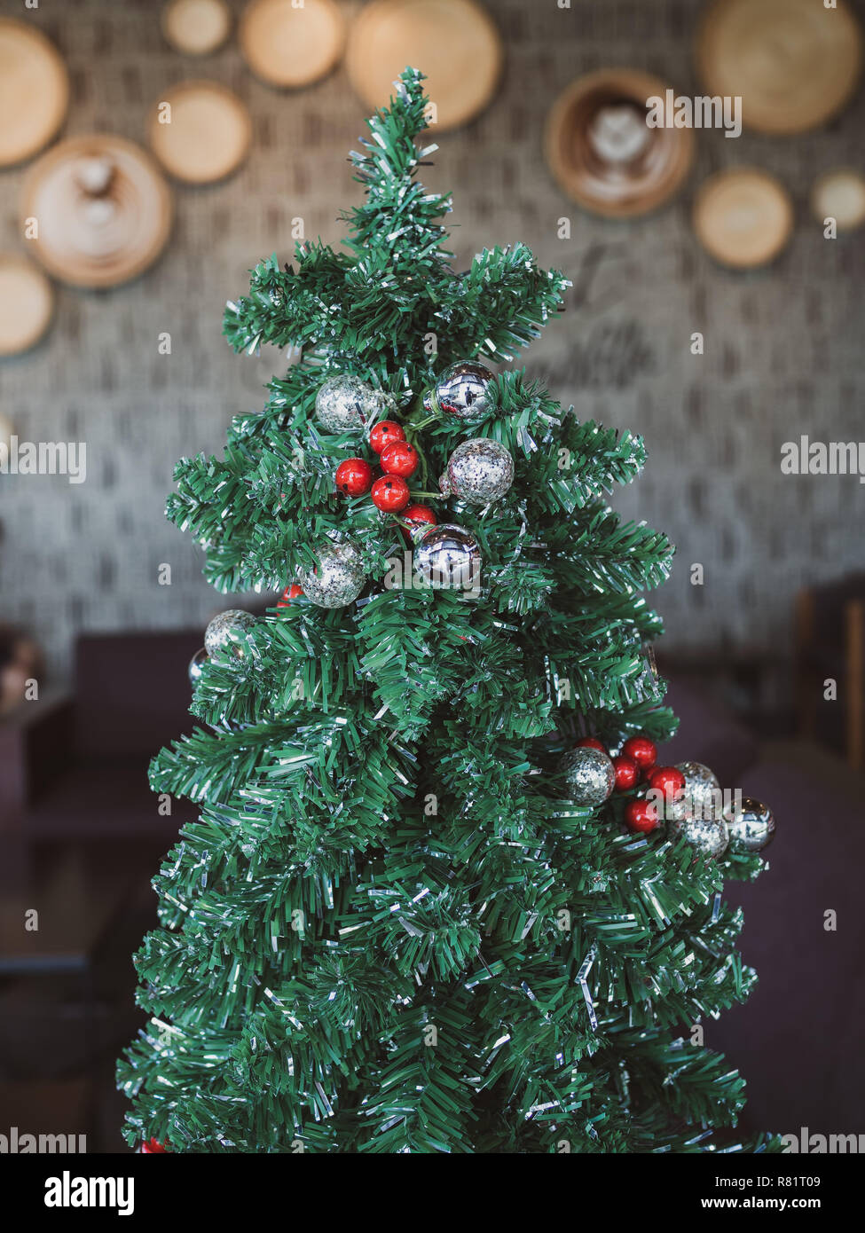 Christmas tree with decoration in cafe background Stock Photo - Alamy