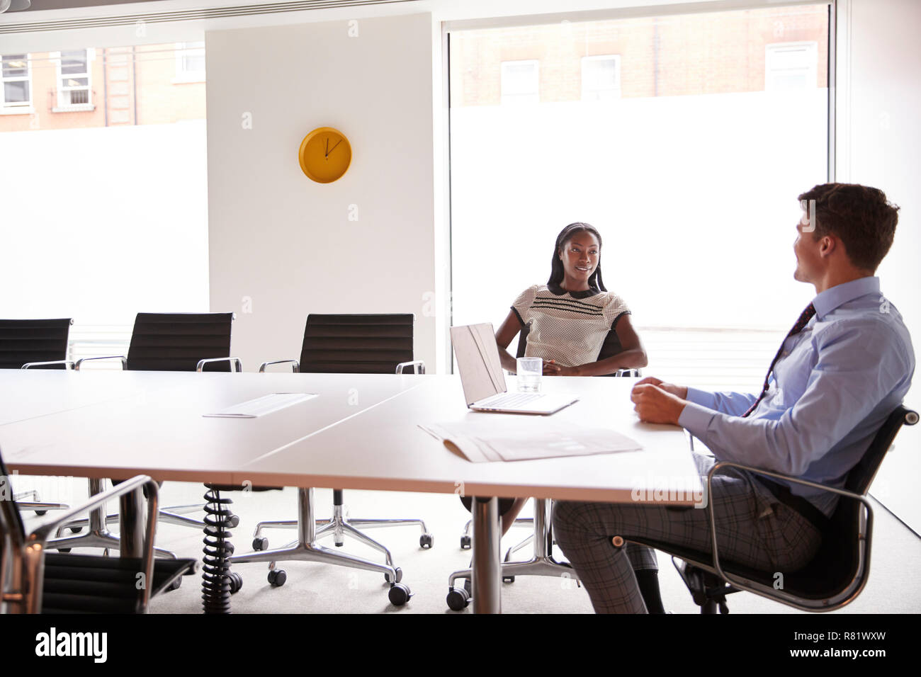 Businessman And Businesswoman Having Discussion Around Boardroom Table ...