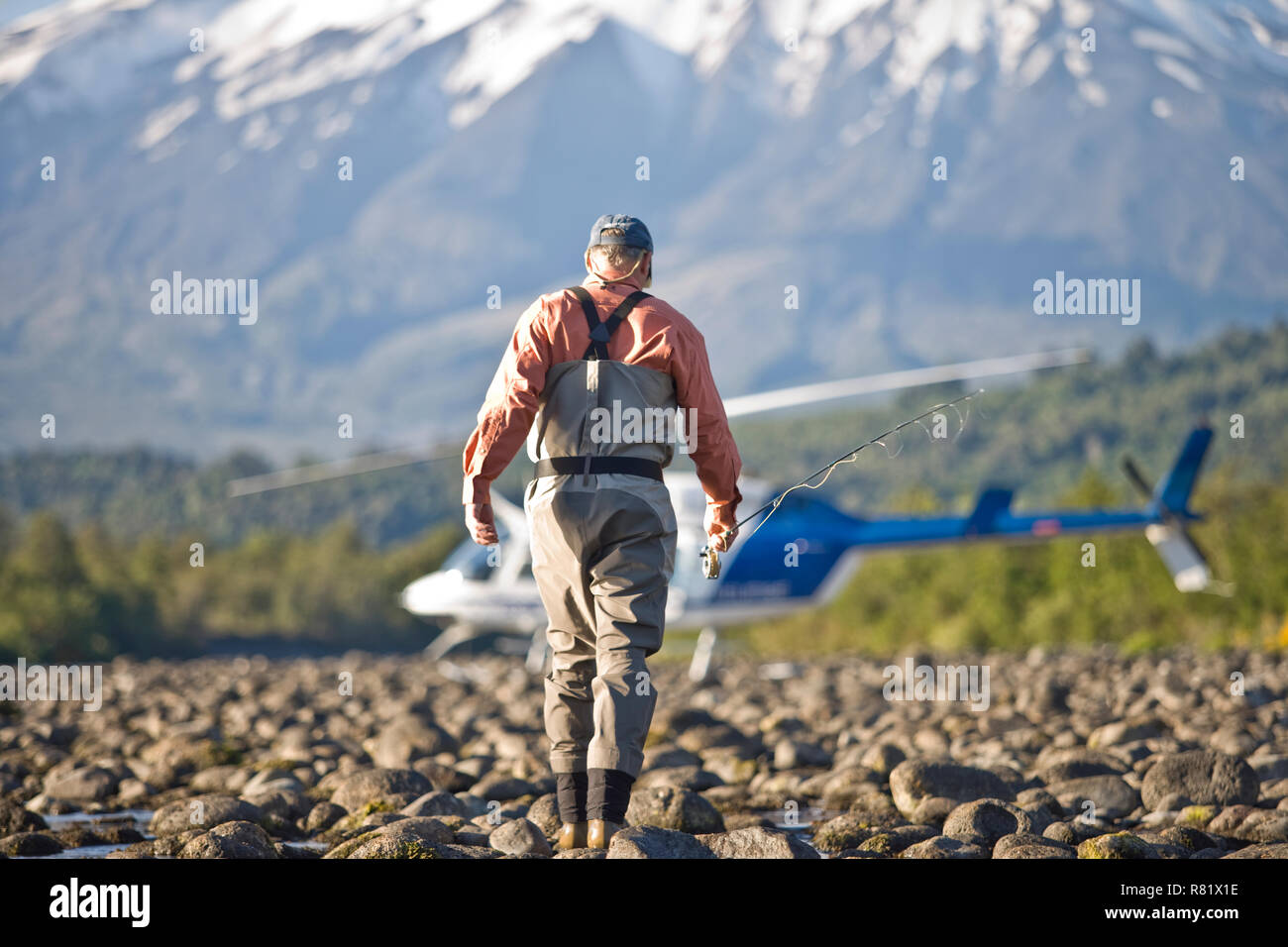 Man walking towards a helicopter Stock Photo - Alamy