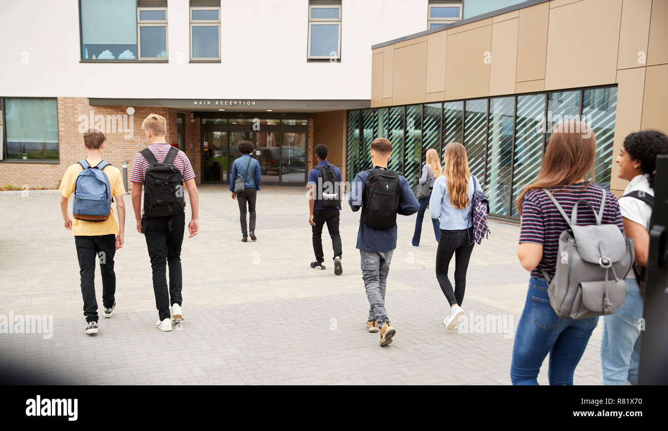 Rear View Of High School Students Walking Into College Building Together Stock Photo - Alamy
