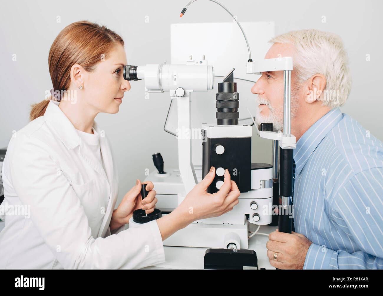 Senior patient checking vision with special eye equipment Stock Photo ...