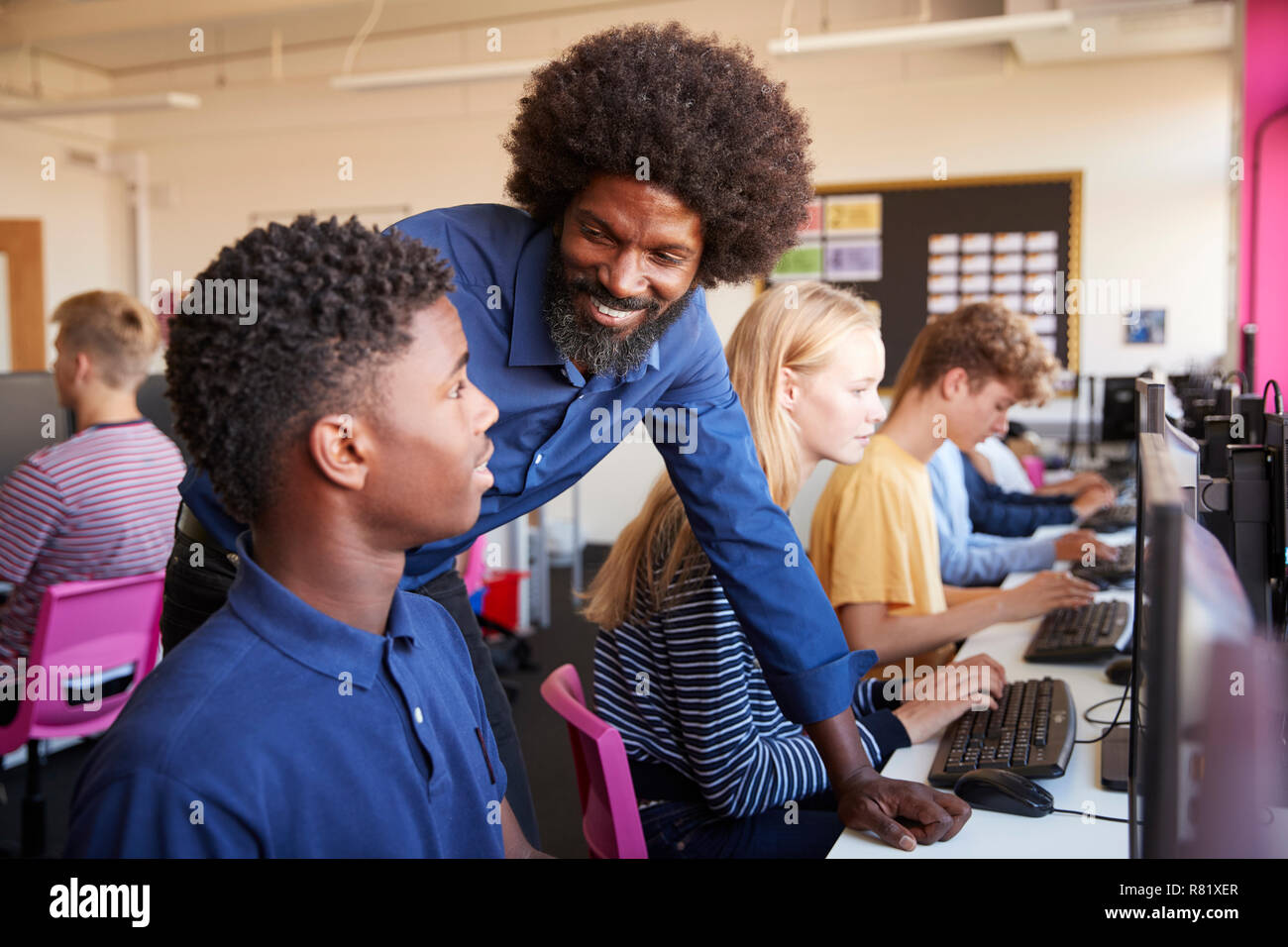 Teacher Helping Student Computer