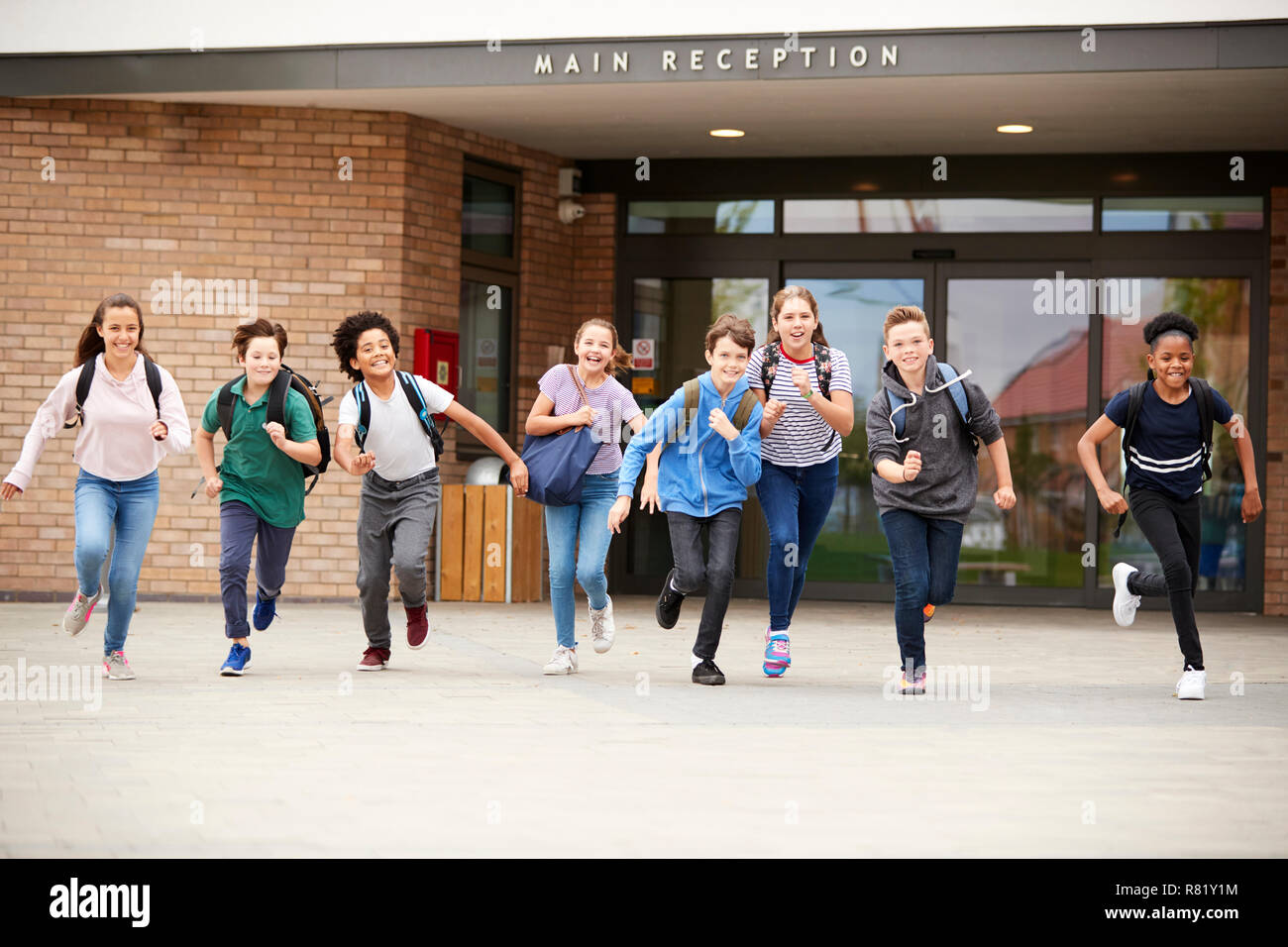 Students running out school hi-res stock photography and images - Alamy