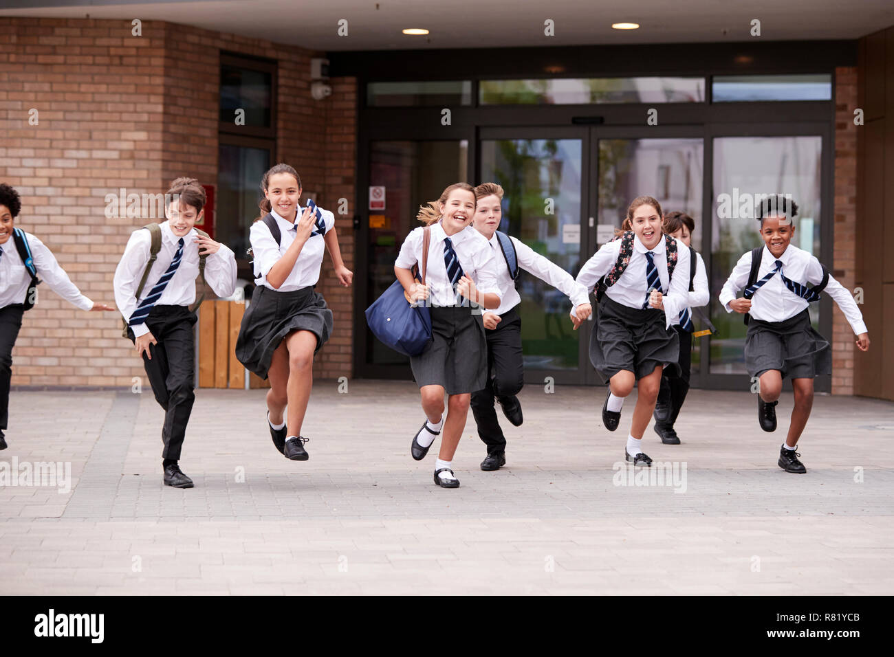 Students running out school building hi-res stock photography and ...