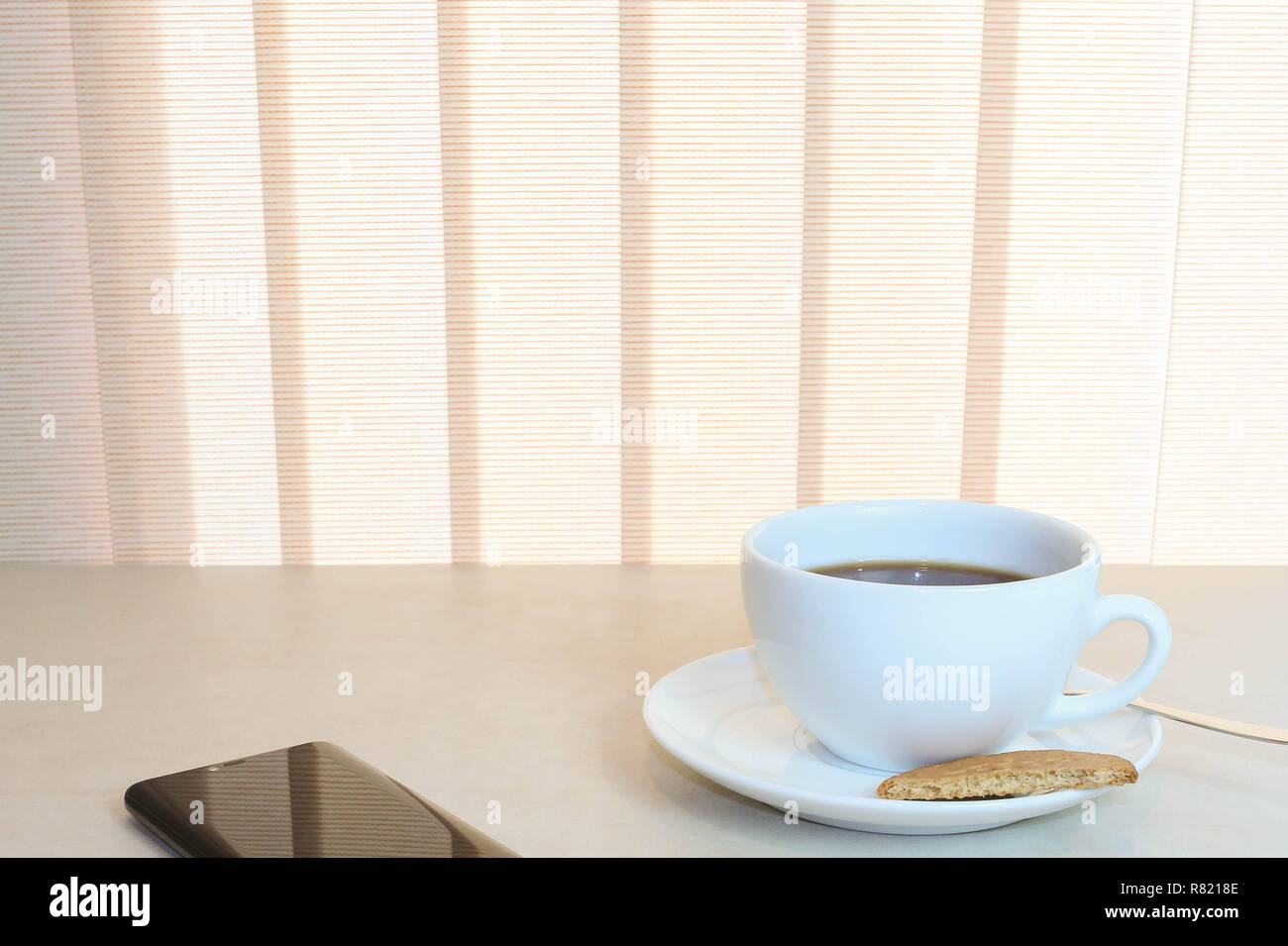 Latest phone, quiet coffee break at work Stock Photo - Alamy