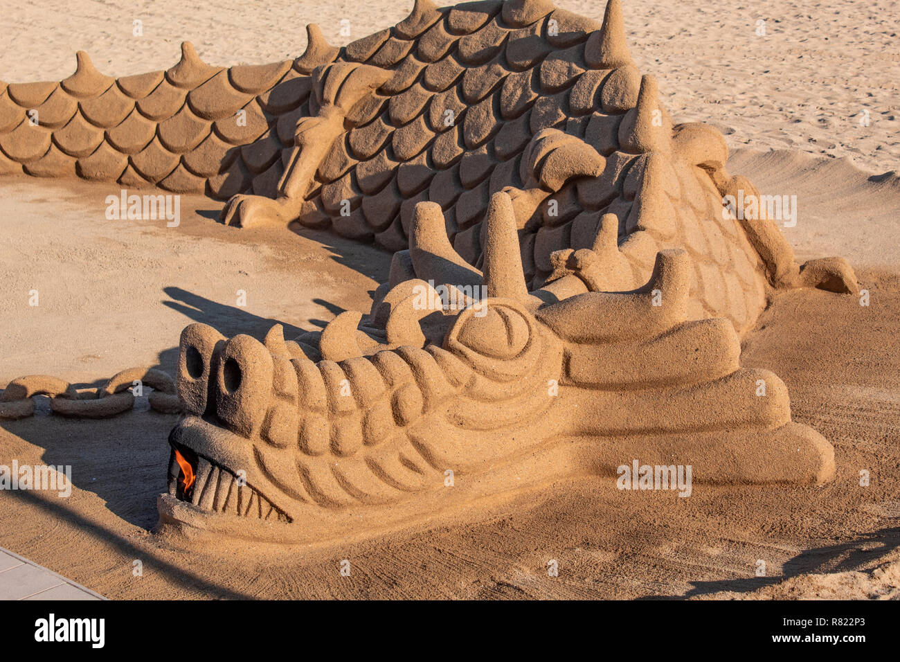 artistic sand sculpture in form of dragon at the beach Stock Photo - Alamy