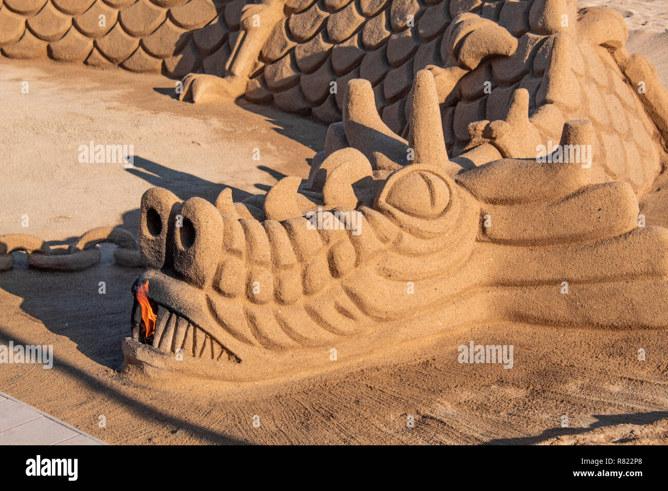 artistic sand sculpture in form of dragon at the beach Stock Photo - Alamy