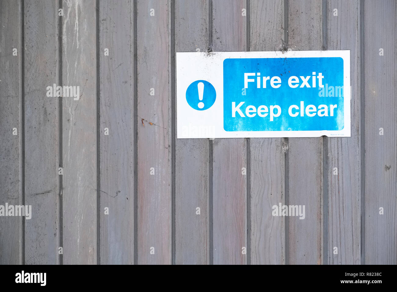 Fire exit keep clear sign wooden door Stock Photo - Alamy