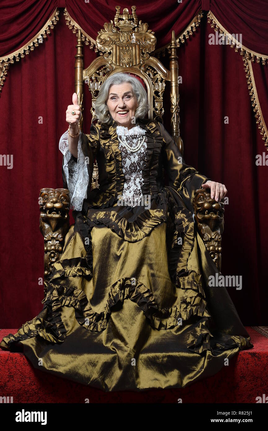 Beautiful senior woman in vintage dress Queen on throne Stock Photo - Alamy
