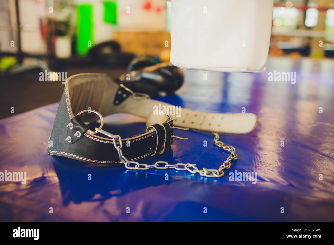 Two black Boxing gloves lie on the Boxing ring in white. The shadow of ...