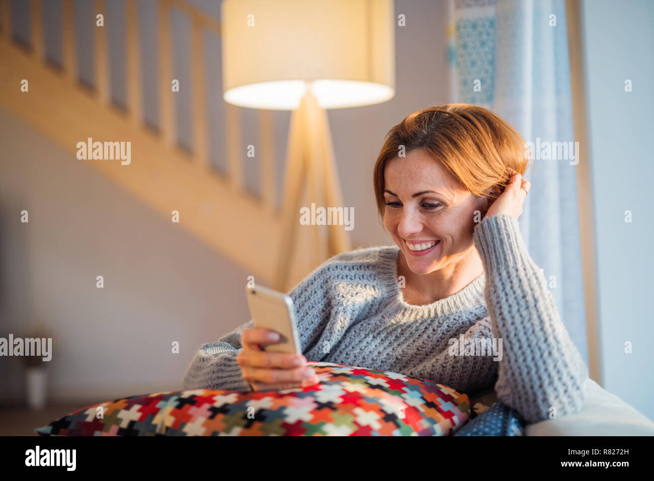 Person on phone at home inside hi-res stock photography and images - Alamy