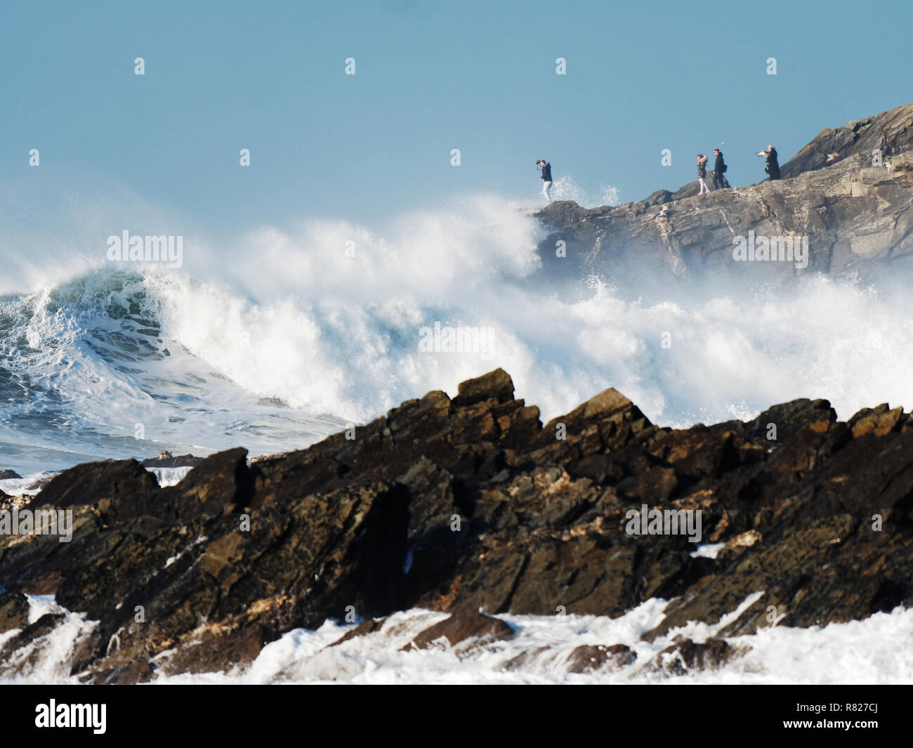 Danger family oblivious to dangerous wave conditions at the coast Stock ...
