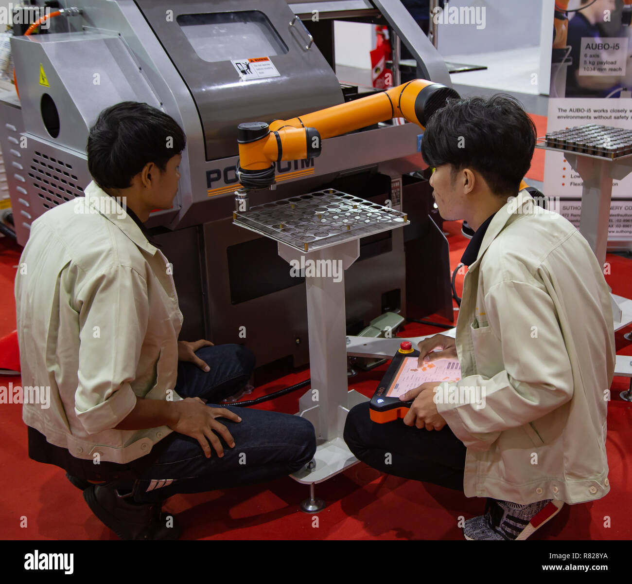 Bangkok, Thailand - November 21, 2018: Worker control robot arm to ...