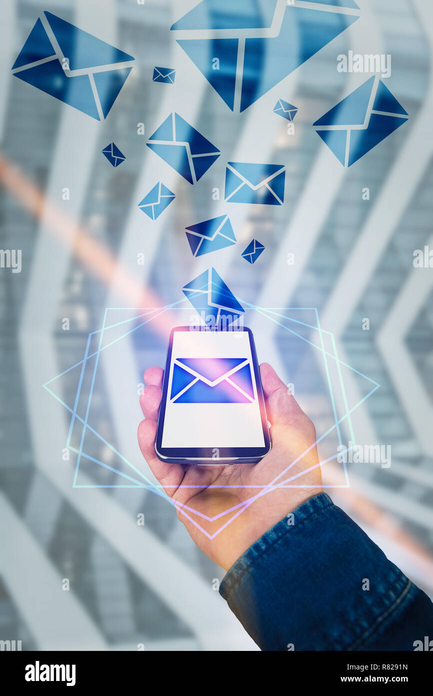 Man hand blue jeans jacket holding a mobile phone sending messages as ...