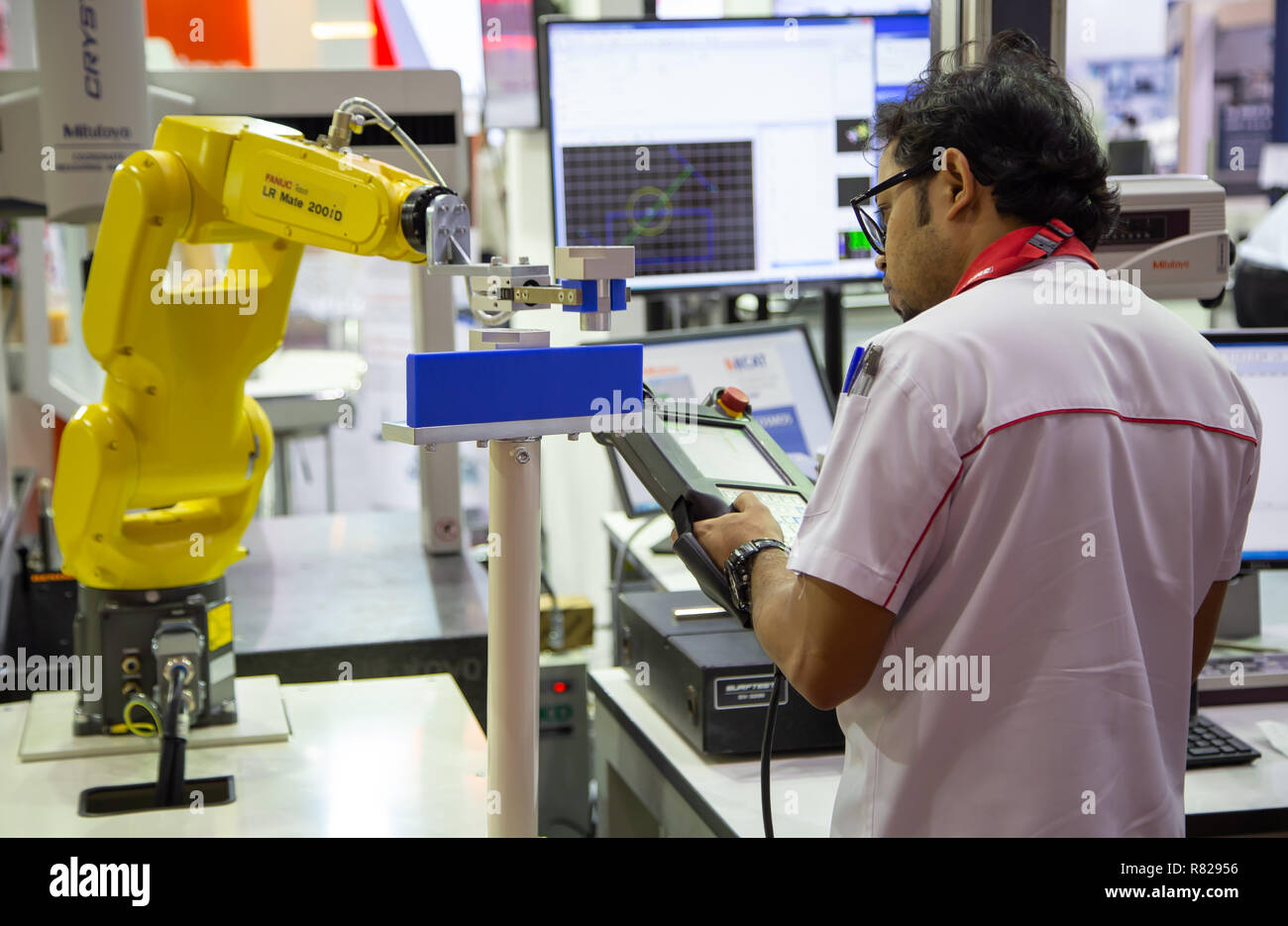 Bangkok, Thailand - November 21, 2018: Worker control robot arm to ...