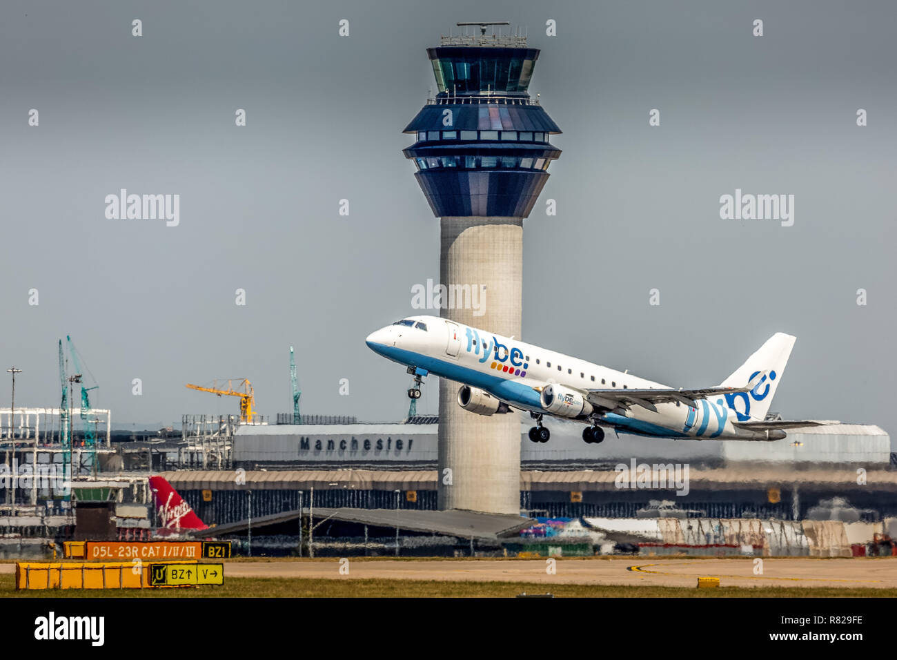 A Flybe Embraer airliner taking off from Manchester Airport in England ...