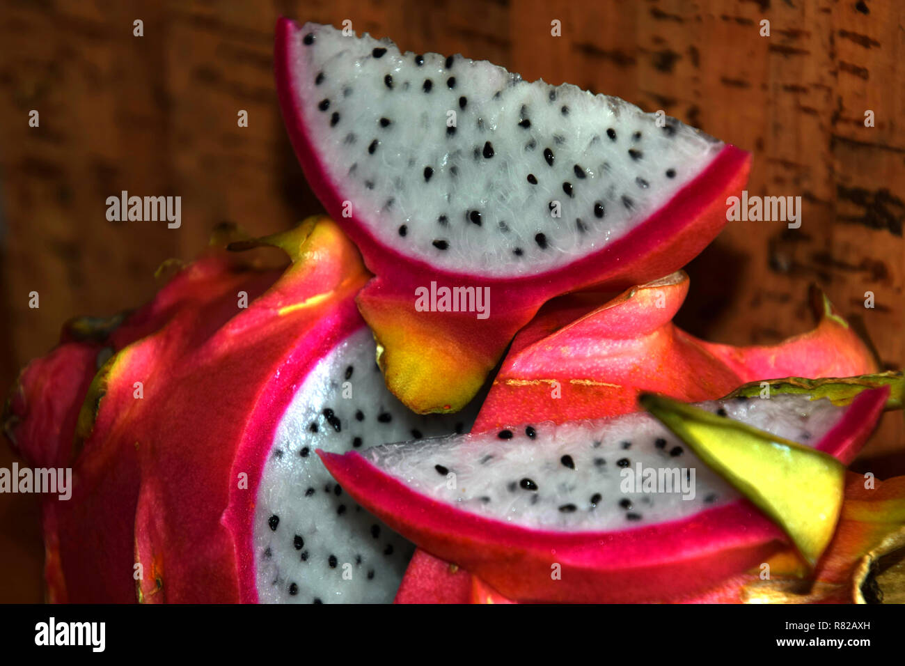 slice of dragon fruit in front of cork background , pitaya blanca or ...