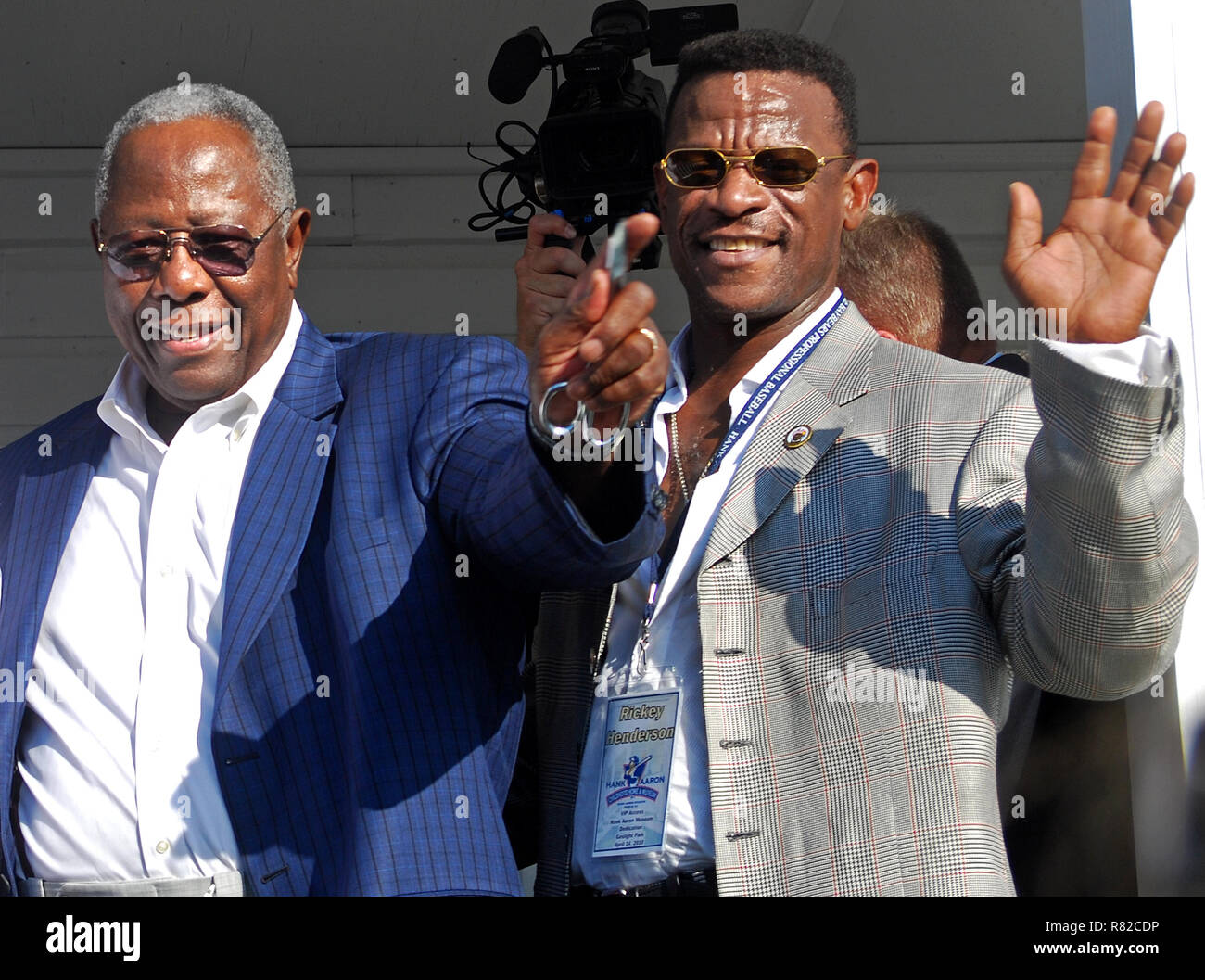 Hank Aaron and Rickey Henderson wave to fans during the dedication of the Hank Aaron Childhood ...
