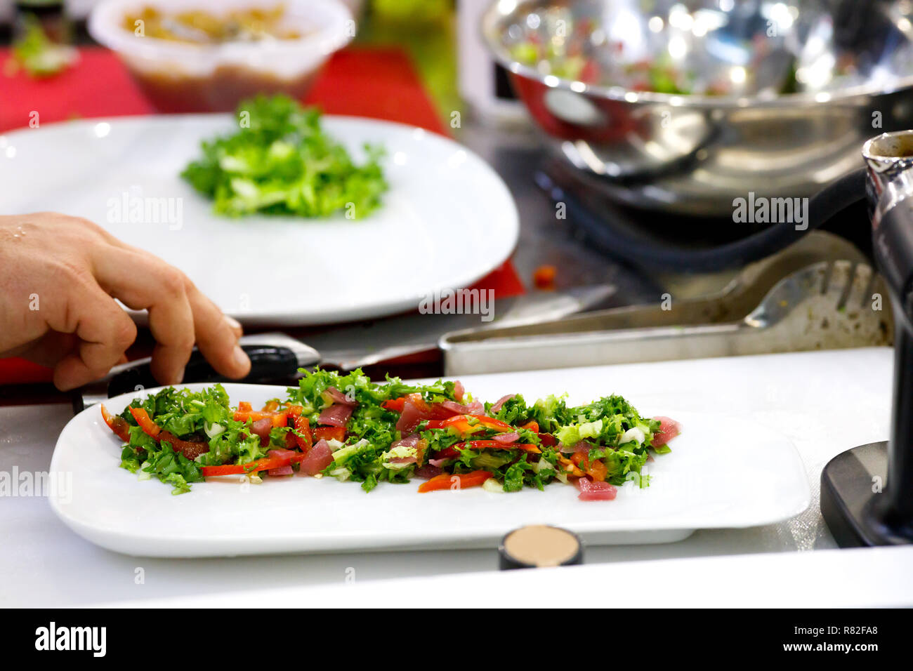 Chef finishing her plate and almost ready to serve at the table. Only ...