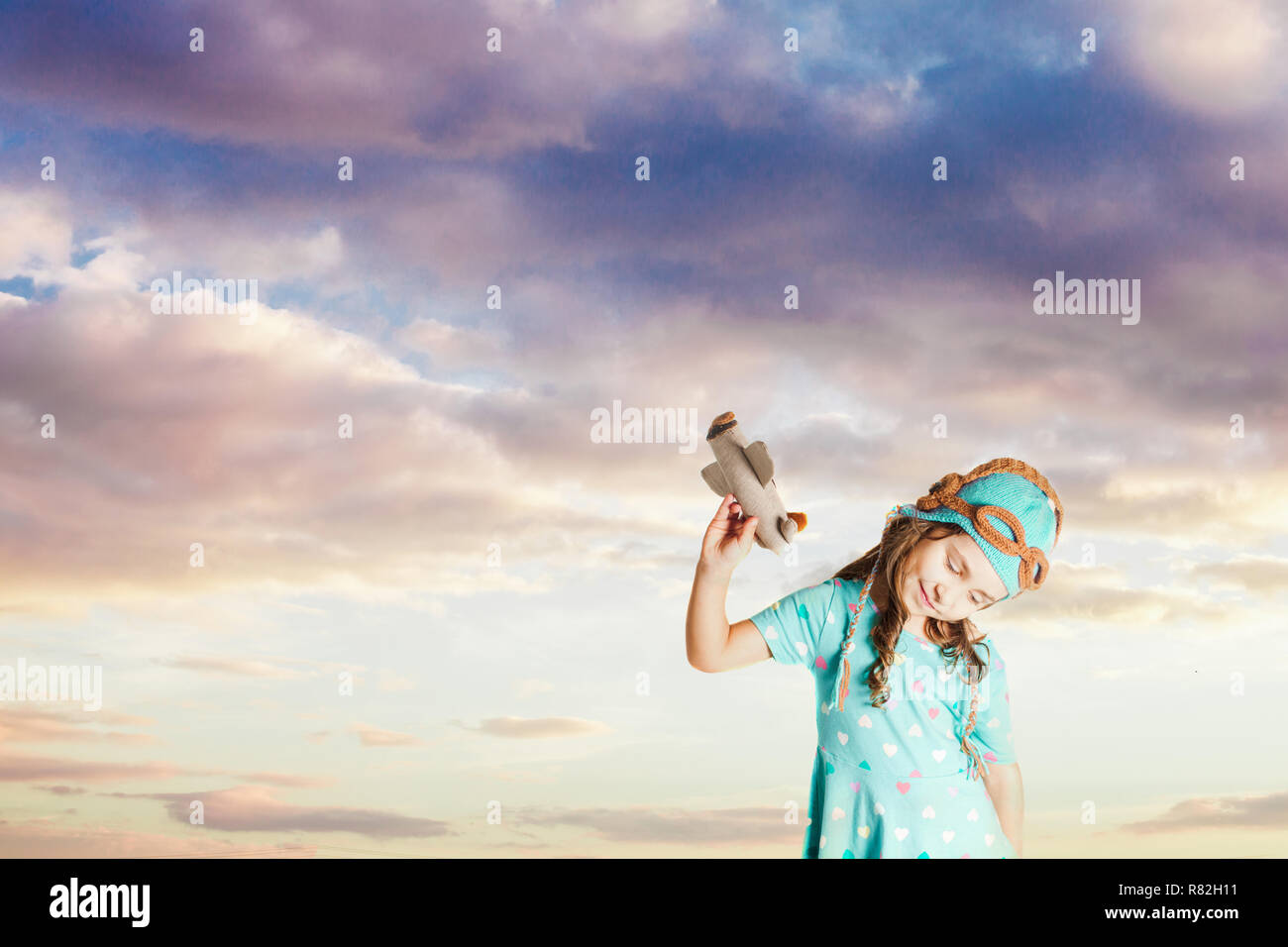 Mused child girl fantasizing herself as a pilot Stock Photo - Alamy