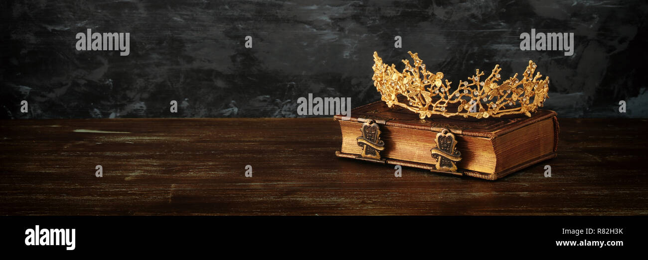 low key image of beautiful queen crown on old book. fantasy medieval ...