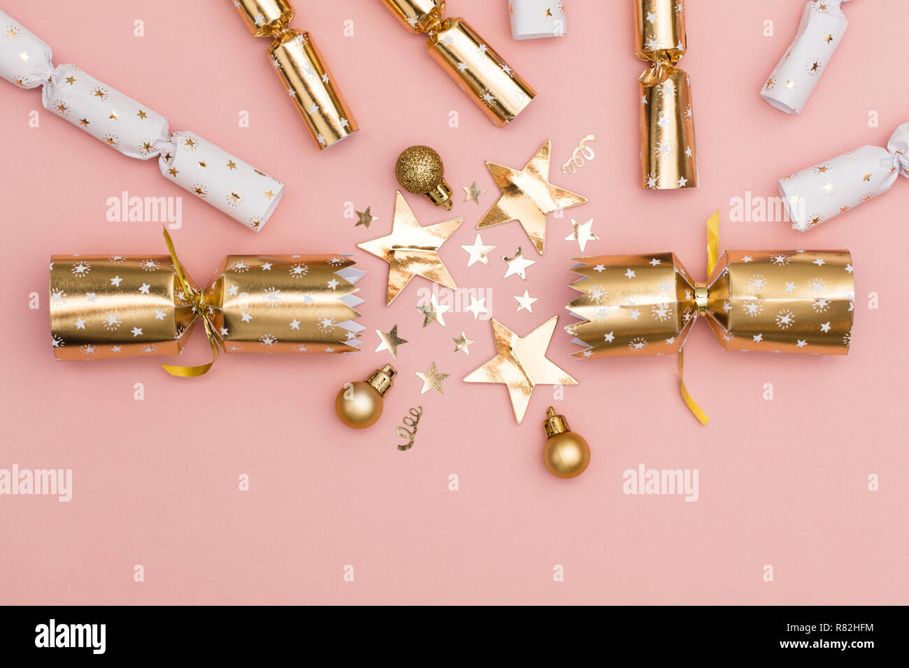 Christmas crackers. luxury gold festive cracker on a pastel pink ...