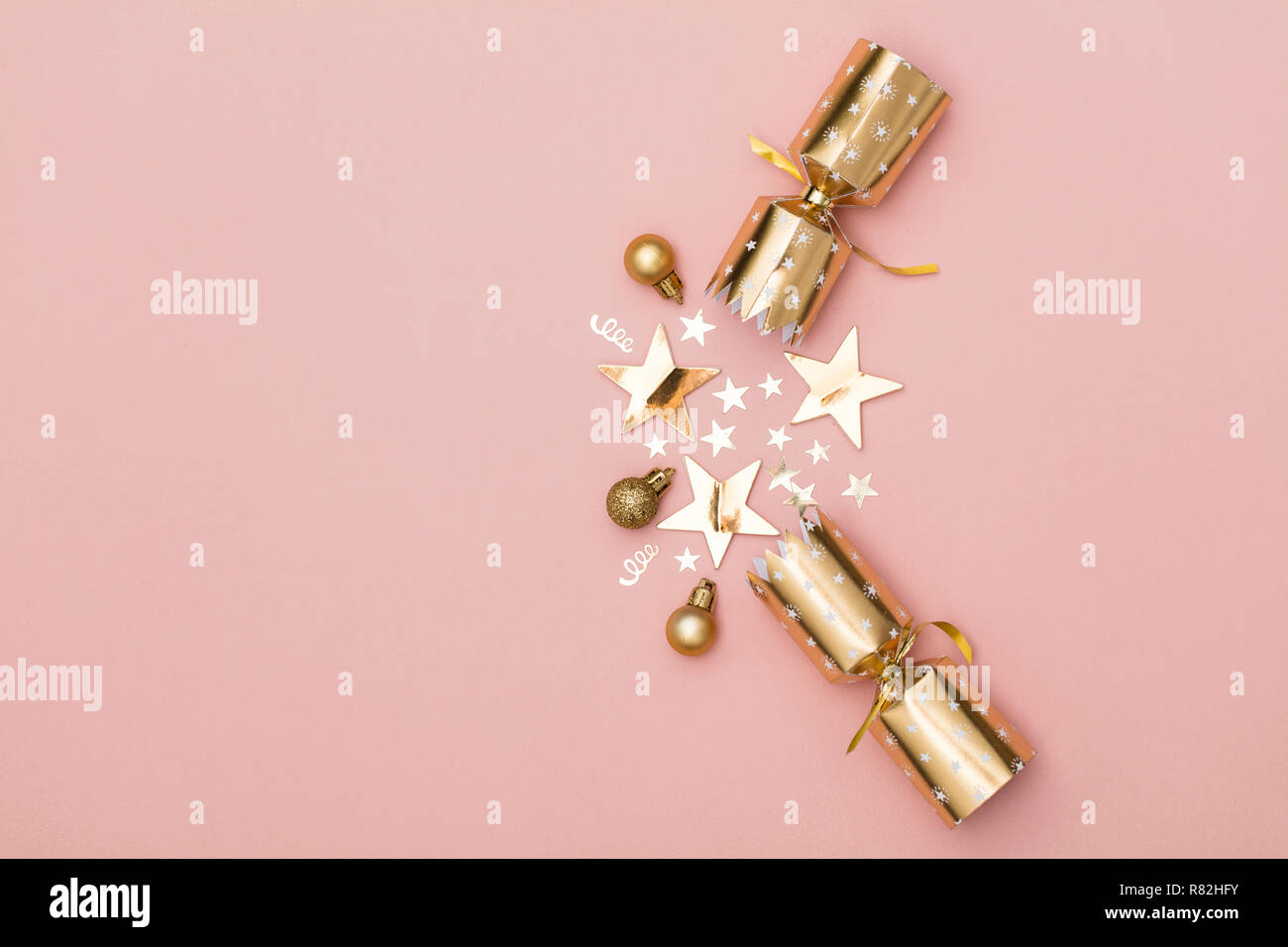 Christmas crackers. luxury gold festive cracker on a pastel pink ...