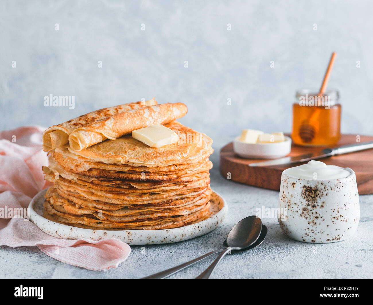 Stack of traditional russian pancakes blini on gray background with ...
