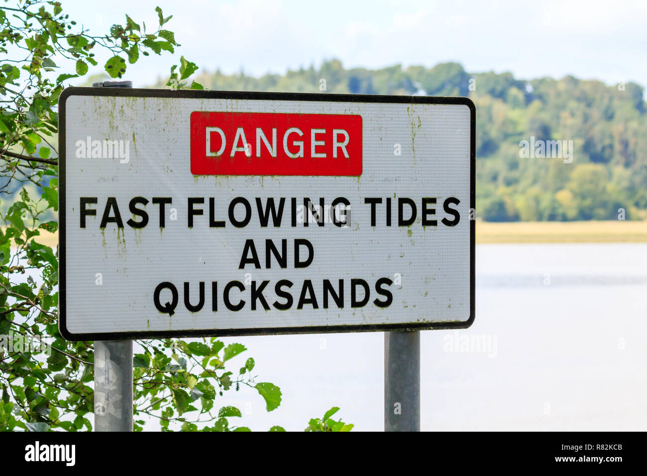 Danger Fast Flowing Tides and Quicksands sign Stock Photo - Alamy