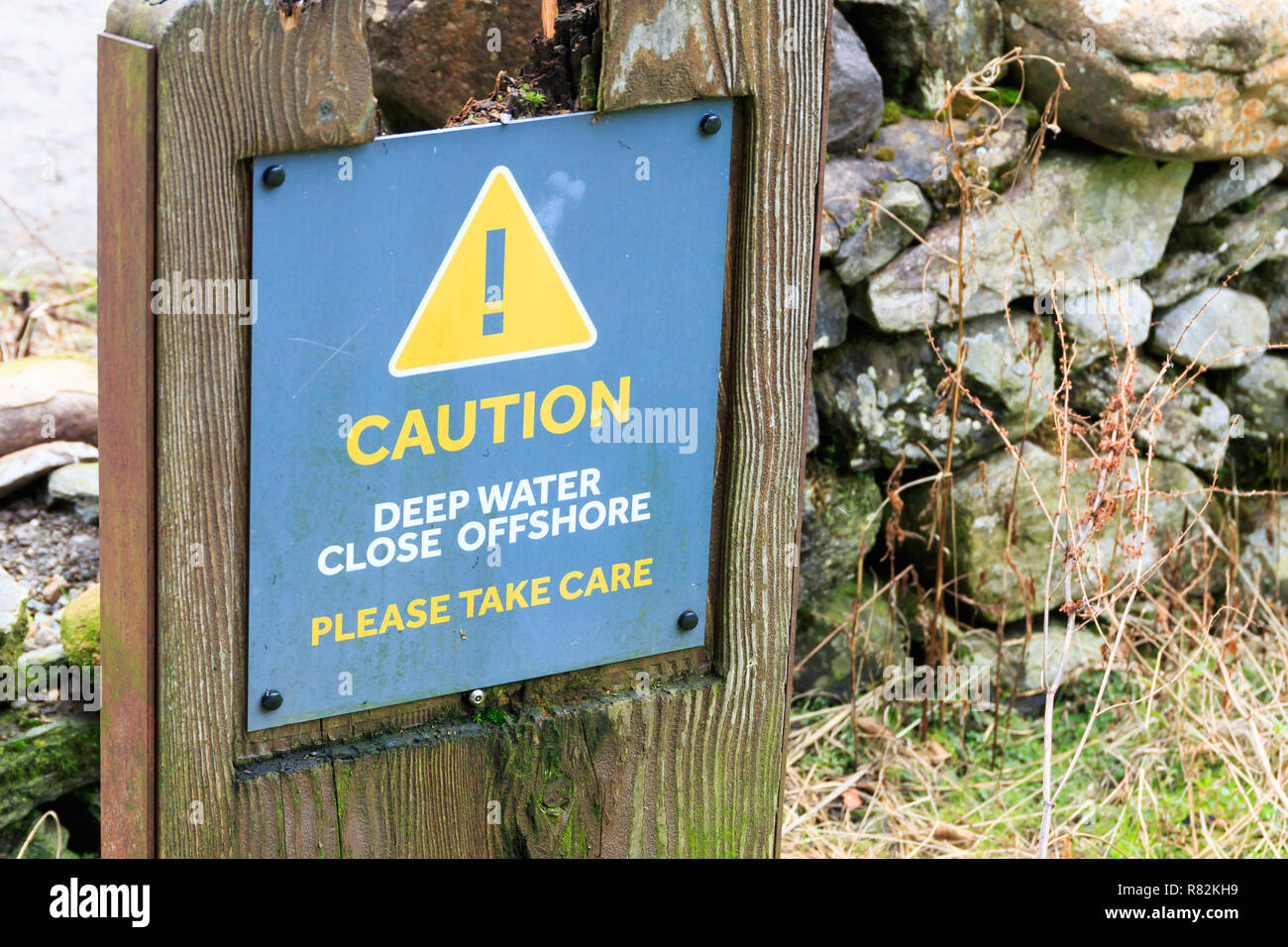 caution sign warning of deep water close to offshore Stock Photo - Alamy