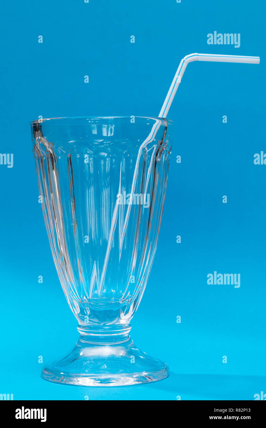 Empty transparent glass with straw isolated on blue background Stock ...