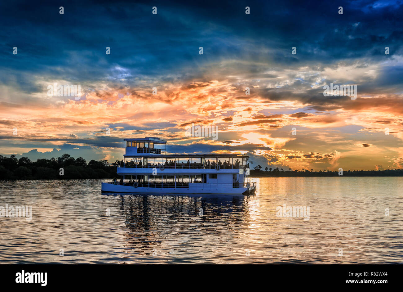 Picturesque sunset landscape with the riverboat at Zambezi river near ...