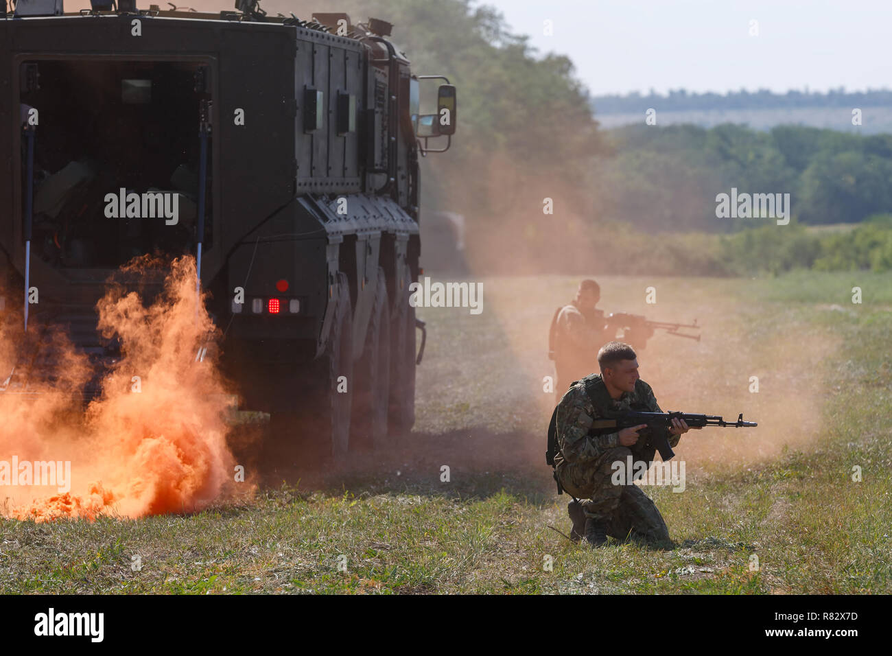 Special Forces soldiers sit with guns around an armored car Stock Photo ...