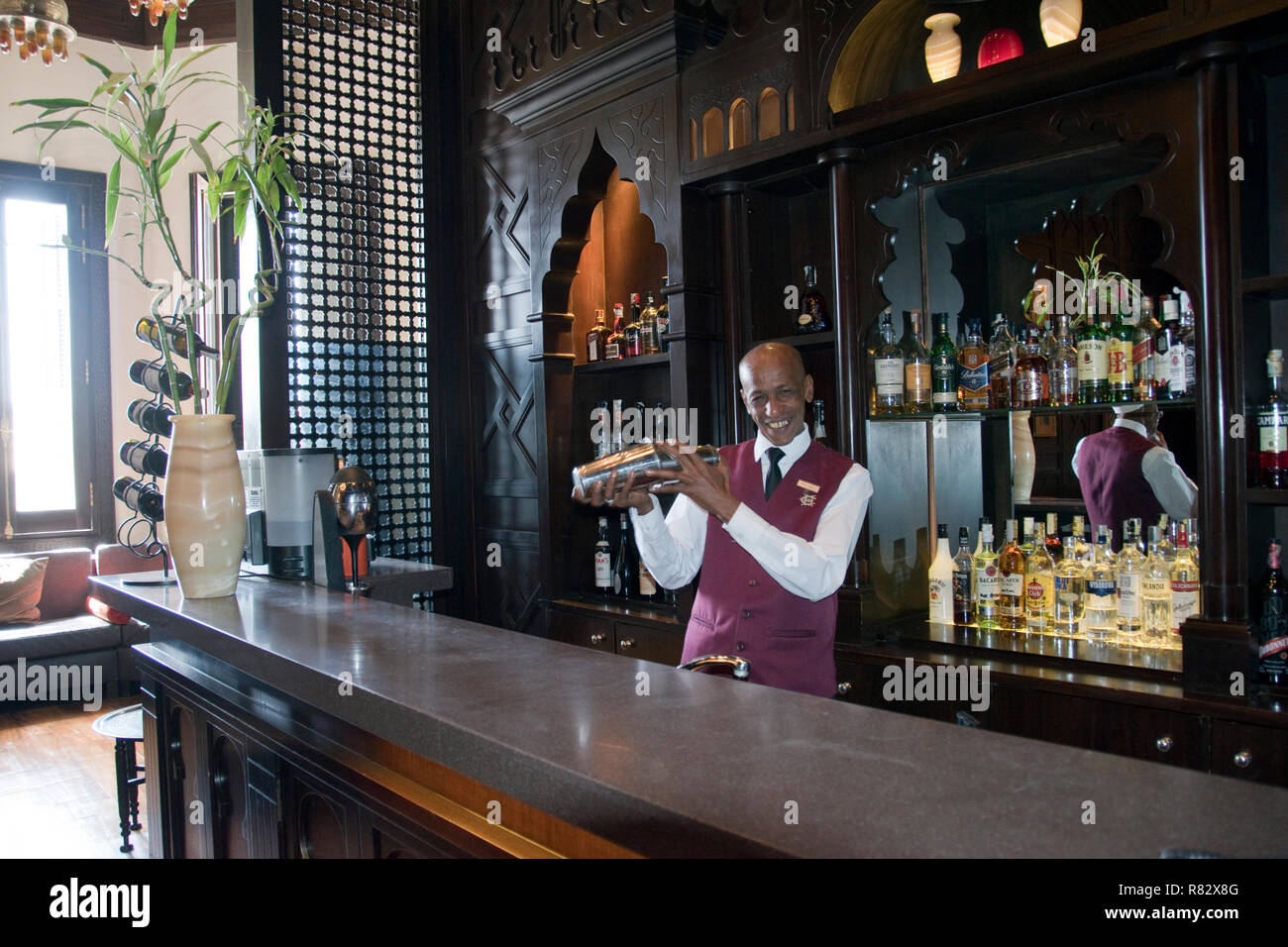 The Nubian bartender shakes a cocktail at the bar of the British ...