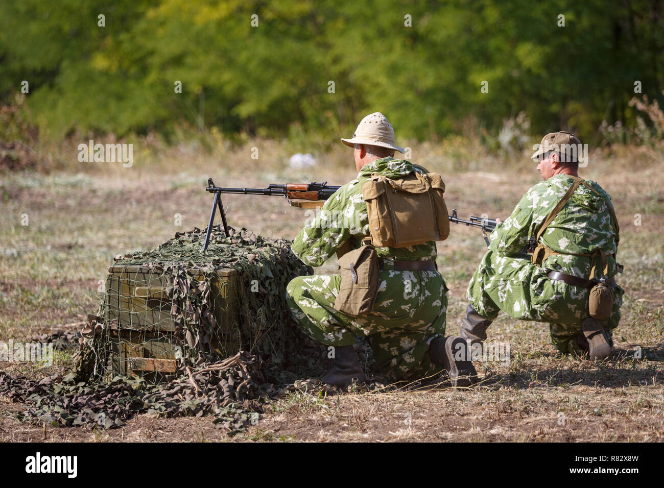 Two Soviet internationalist warriors in camouflage cloth sit with ...