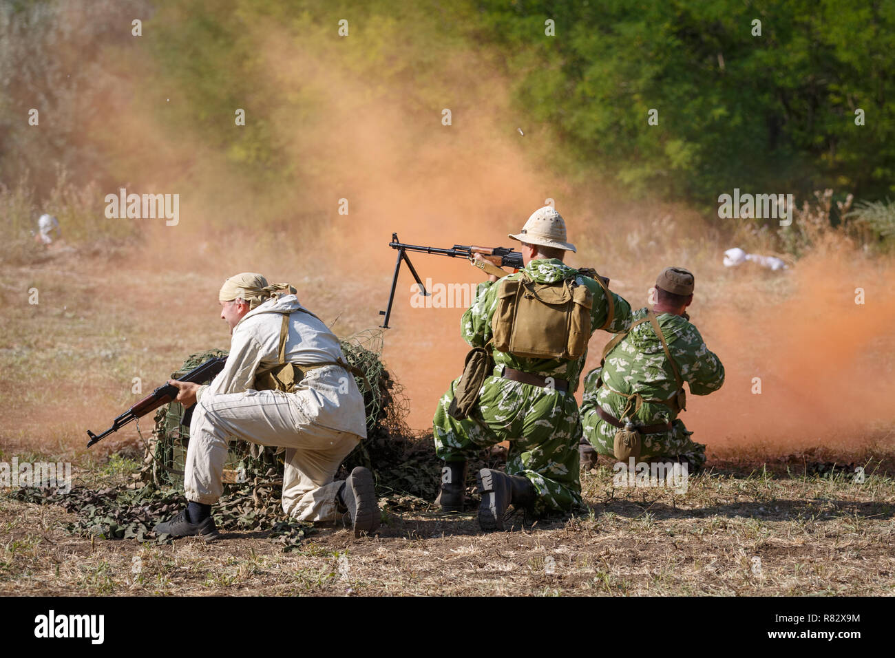 Three Soviet soldiers is beating off the attack of the mujahideen using ...