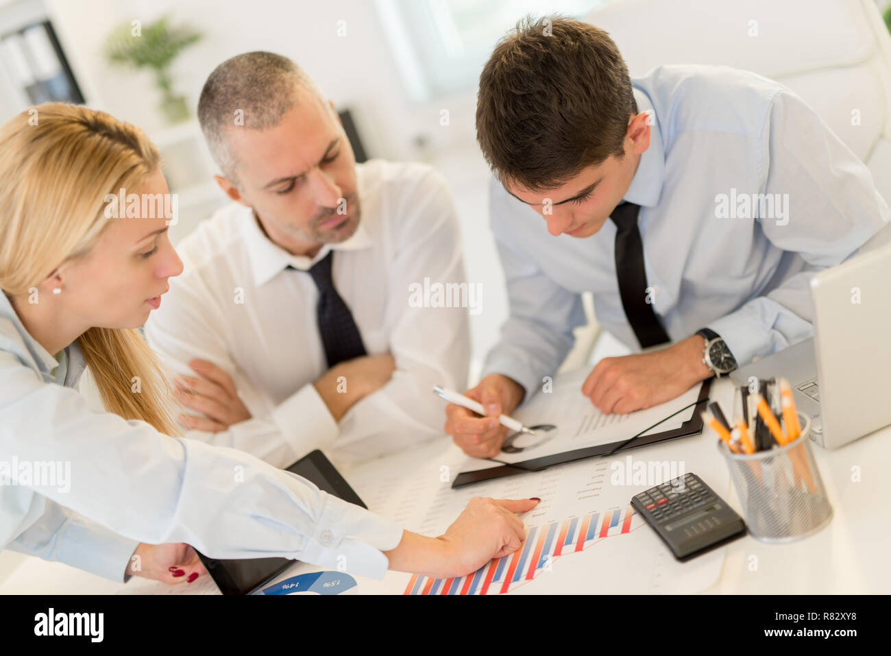 Business people having a meeting. Three business people looking at ...
