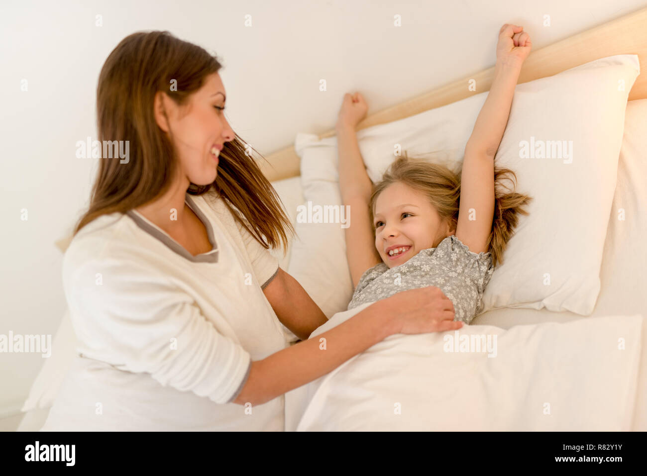 Mother waking her daughter up hi-res stock photography and images - Alamy