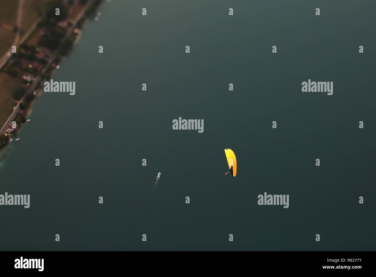 Several tandem pilots and their respective passenger flying over Lake ...