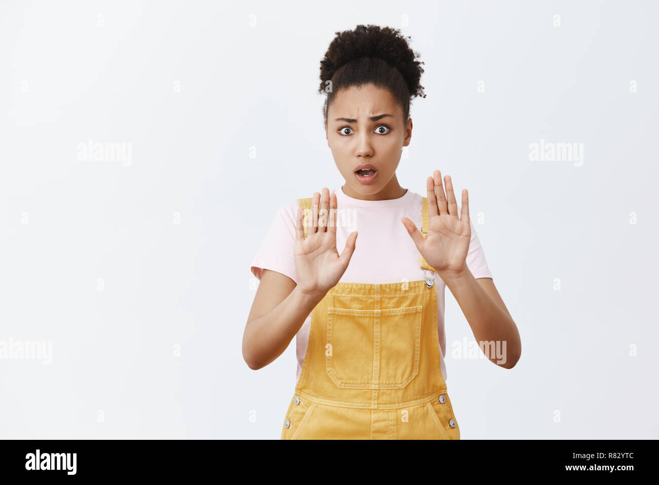 Calm down, put gun down. Intense worried and nervous scared african ...