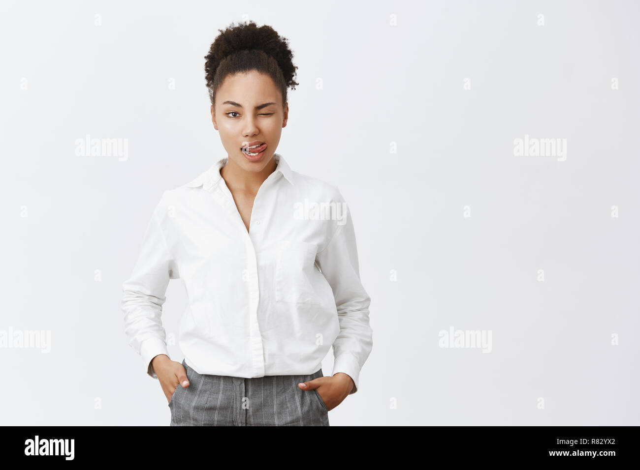 Daring woman come on date in formal outfit, sticking out tongue and ...