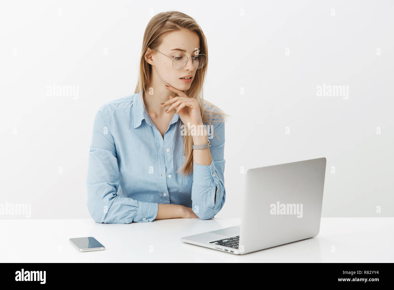Dedicated female worker staying in office late as finishing business ...