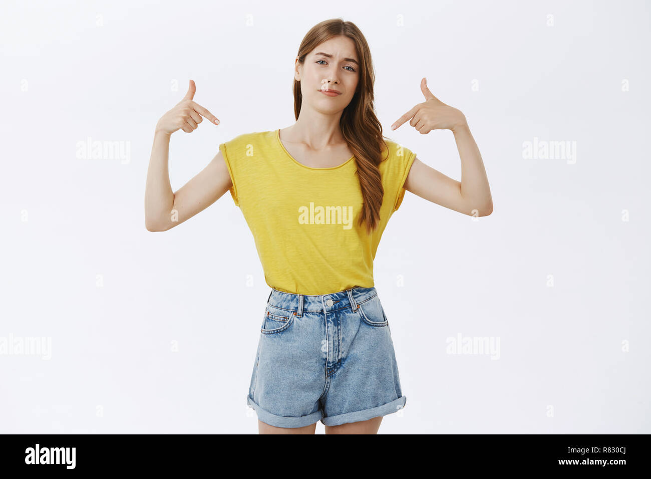 Portrait of arrogant confident and proud good-looking female in yellow ...
