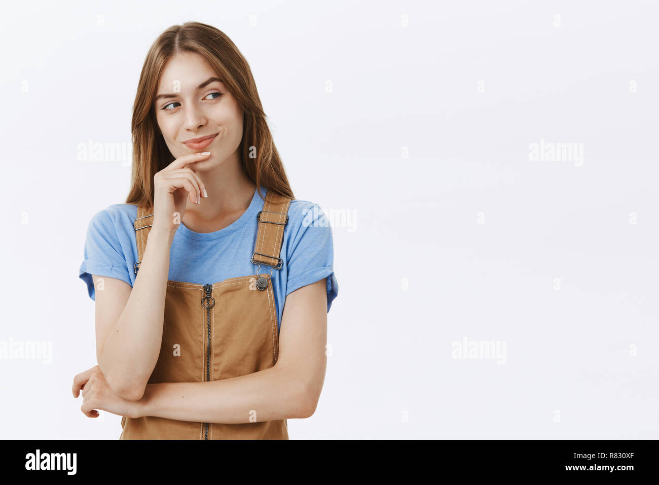 Tricky intelligent and creative good-looking female in overalls ...