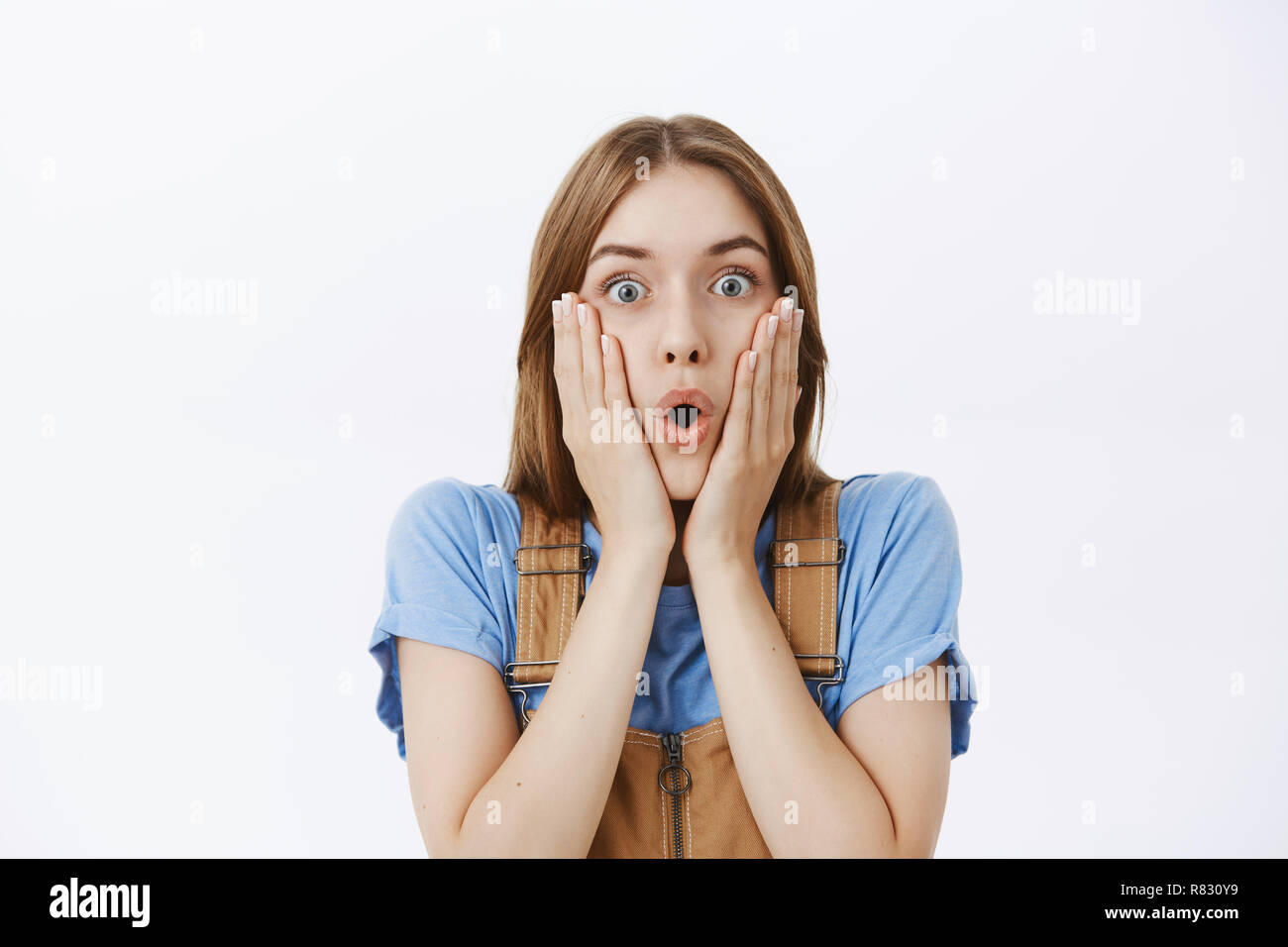 Waist Up Shot Of Amazed And Surprised Good Looking Impressed Woman