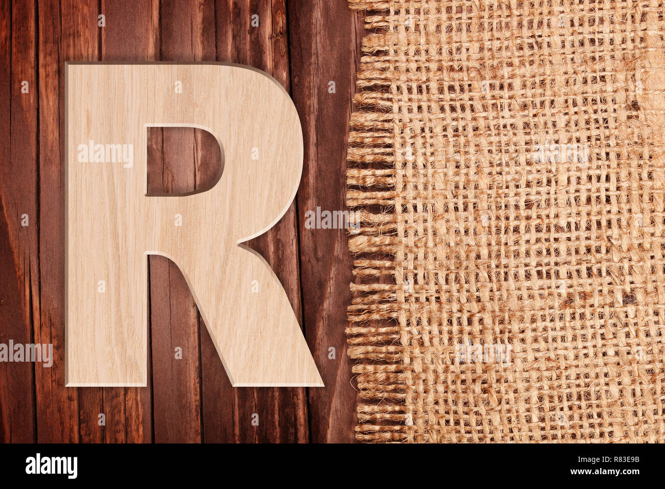 Wooden alphabet letter symbol - R. On wooden table background wih ...